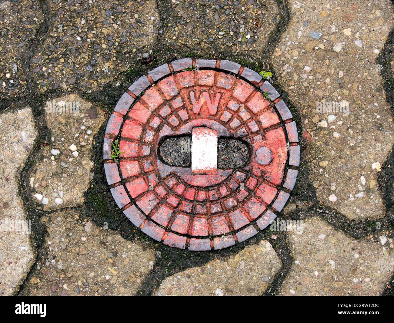 Small red underground hydrant Stock Photo - Alamy