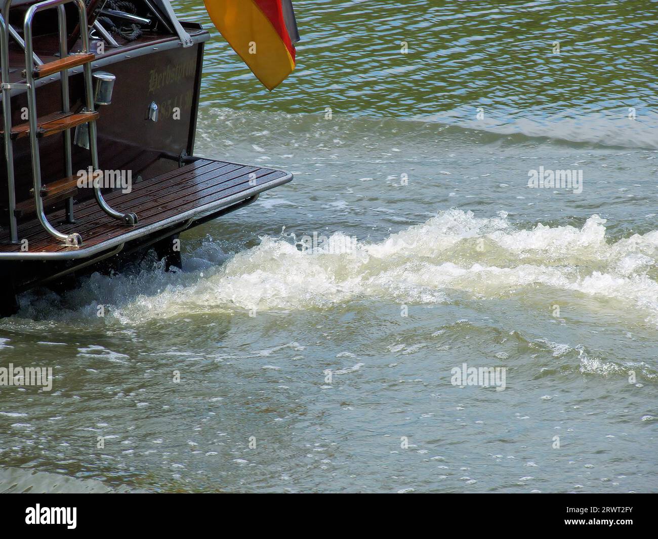 Spray behind boat Stock Photo - Alamy