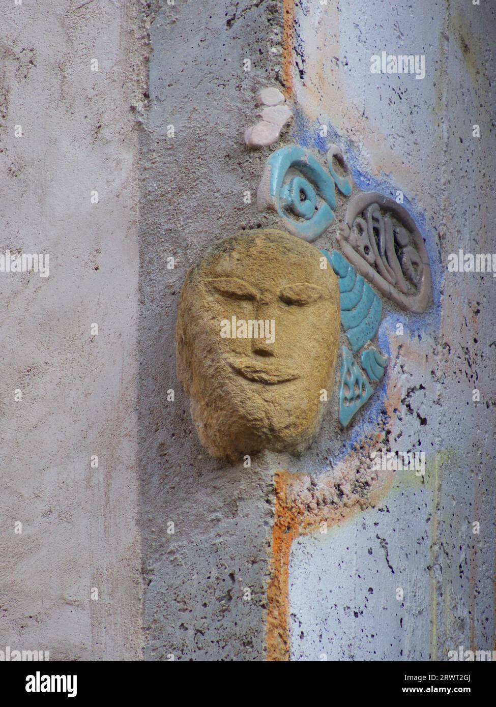 Various artistic objects on the corner of a house Stock Photo - Alamy