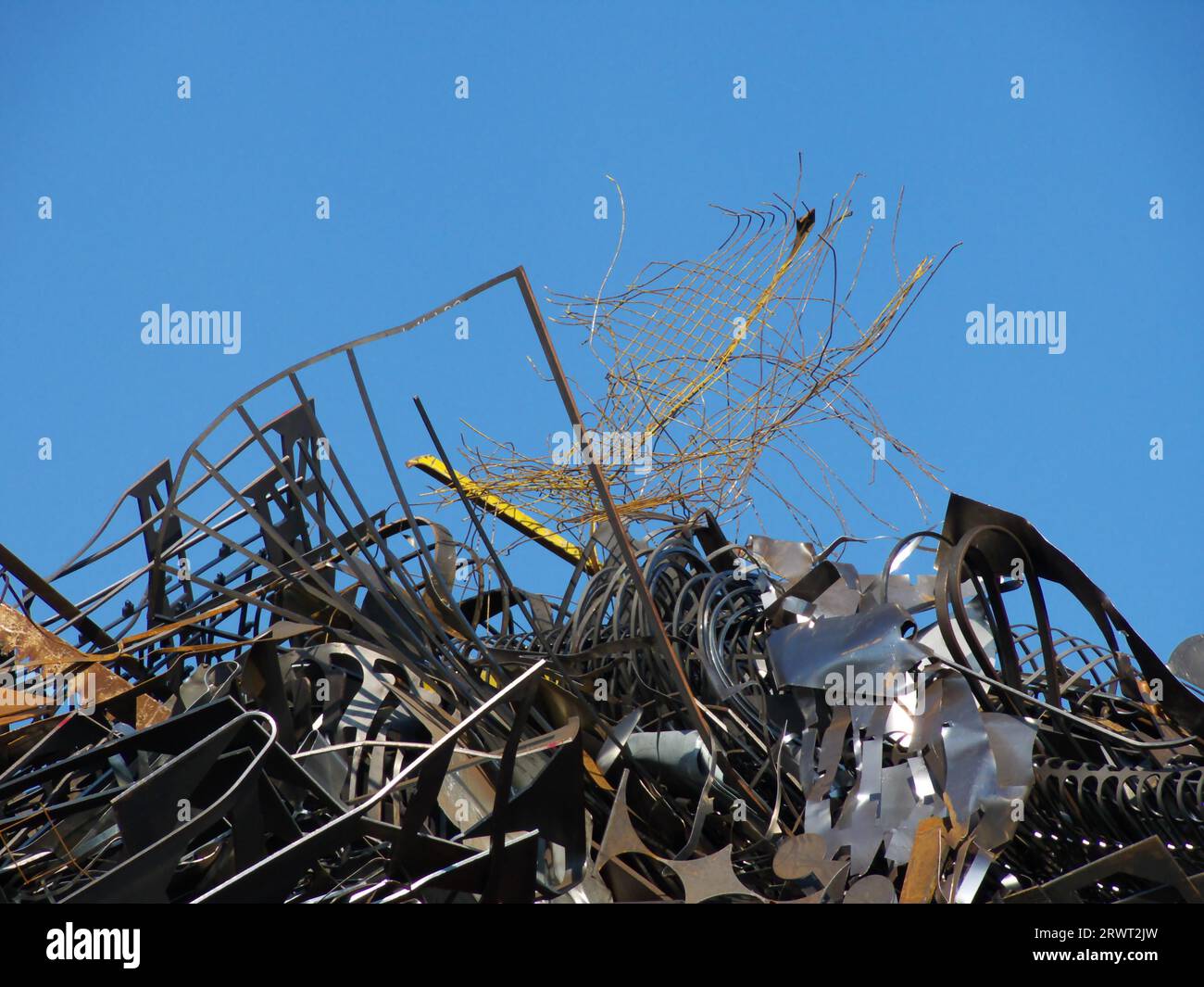 On the scrap heap, scrap metal in various shapes and colours, some of ...