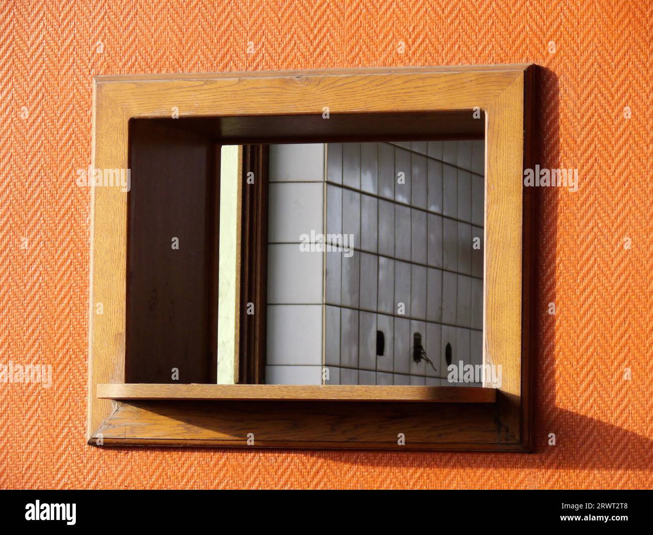 View through a hatch into a sanitary room with soiled white tiles (the ...
