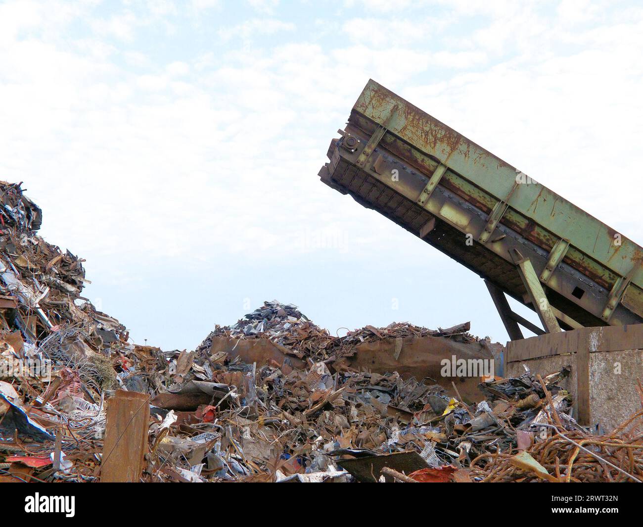 Ramp on a scrap metal dump, background blue sky Stock Photo - Alamy