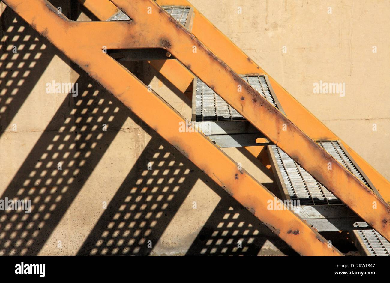 Yellow metal staircase with shadow cast, detail, full-size Stock Photo ...