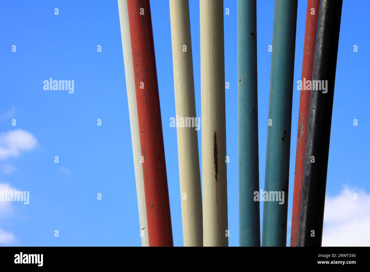 Six wooden sticks in different colours, cut-out, background blue sky ...