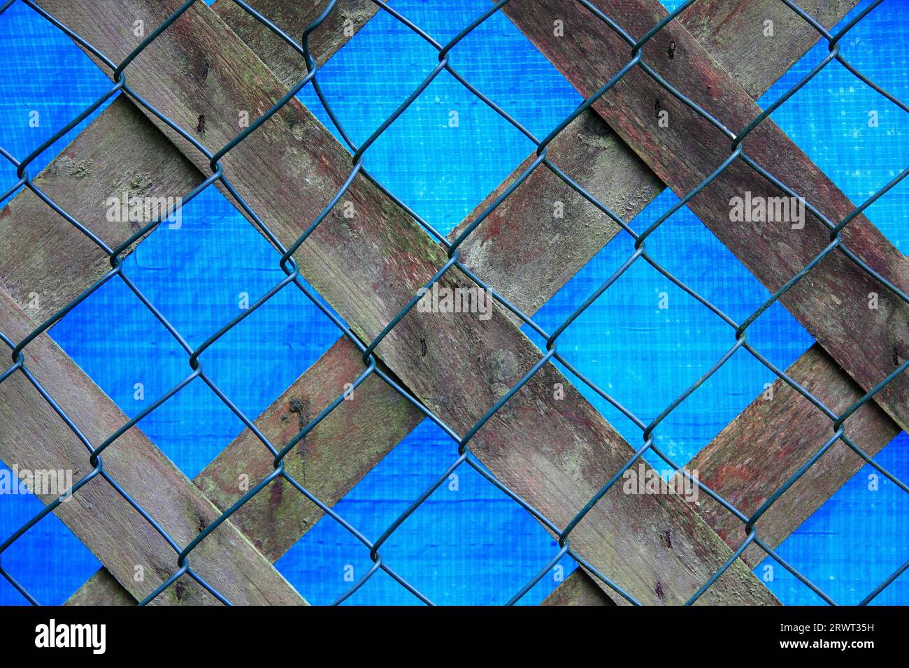 Private privacy screen and barrier, blue tarpaulin, board shack and ...