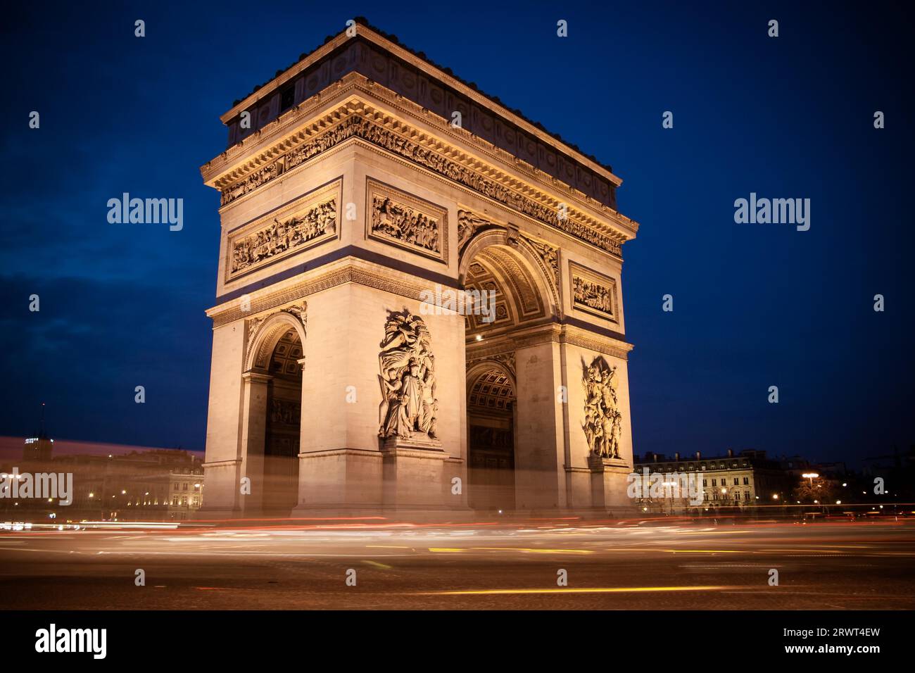 Rush hour traffic drives around the Arc de Triomphe in Paris, France ...