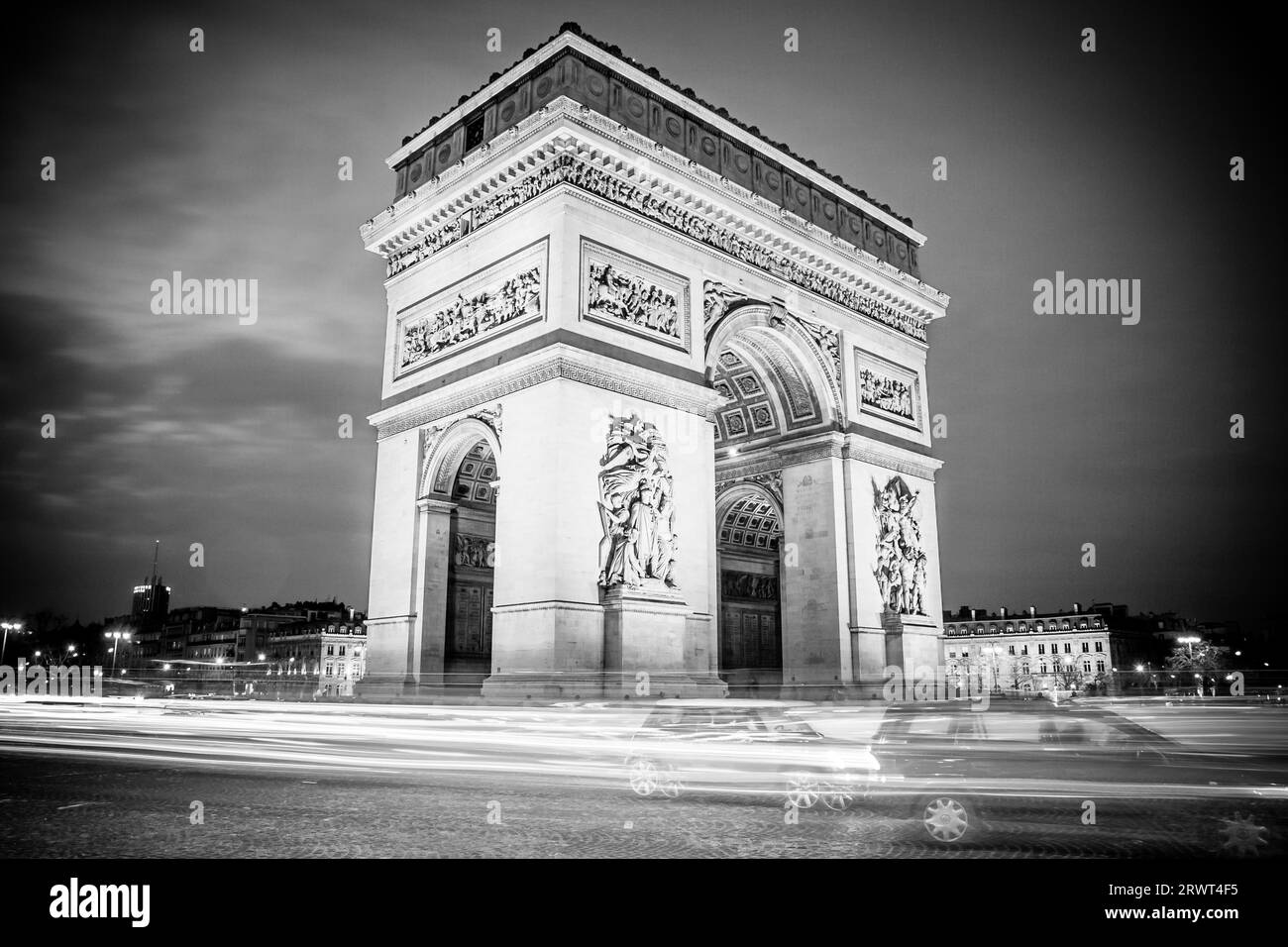 Rush hour traffic drives around the Arc de Triomphe in Paris, France ...