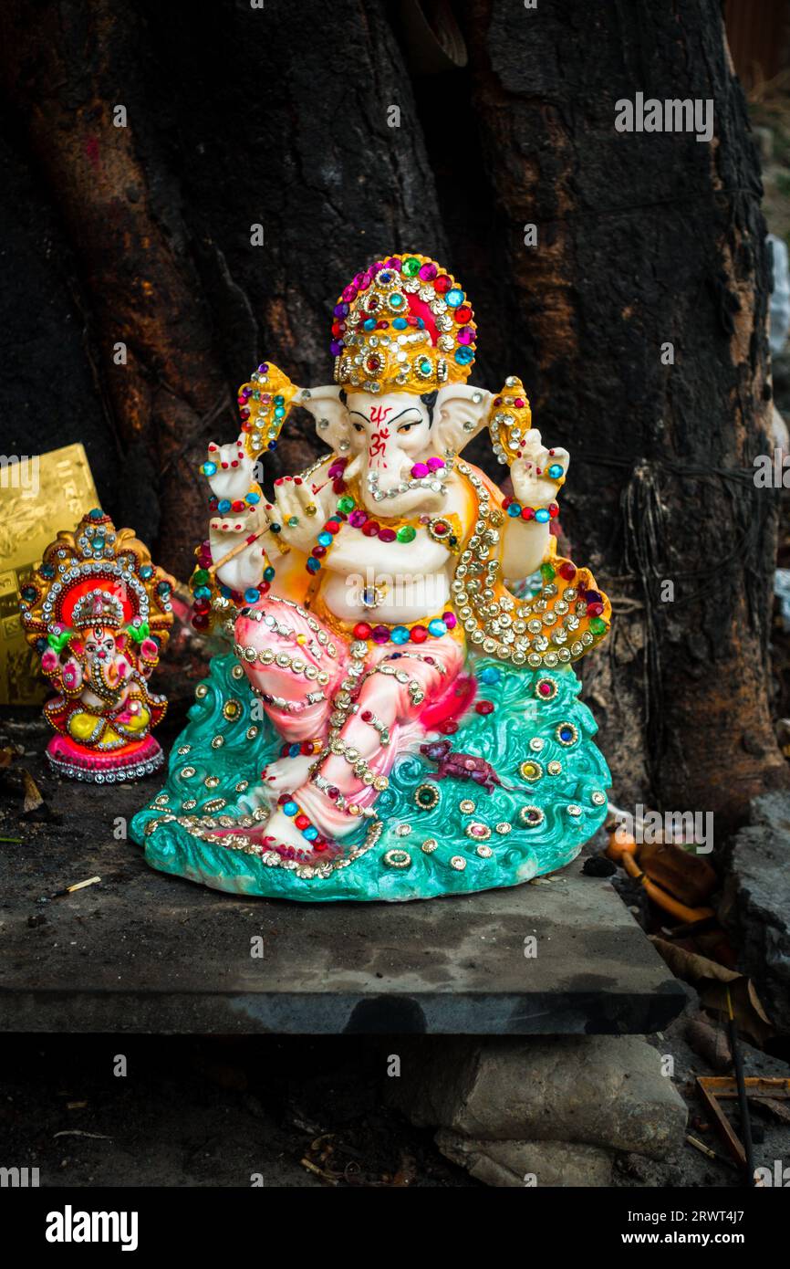 Sculpture of Lord Ganesha beneath a tree, used for worship. Uttarakhand ...