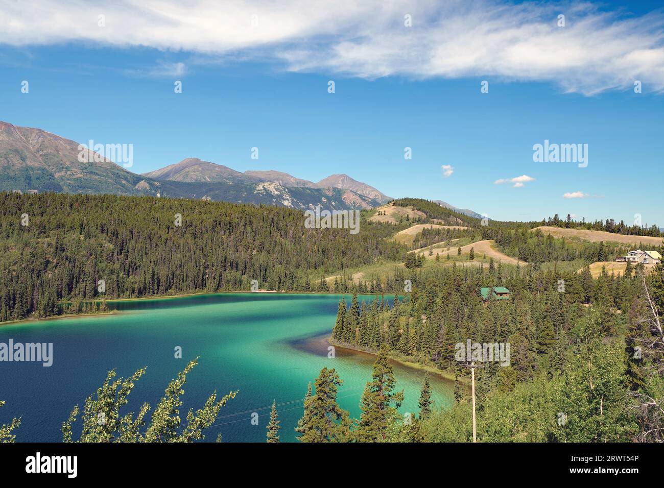 x–Transparent clear lake with green water colour, forest and mountains ...