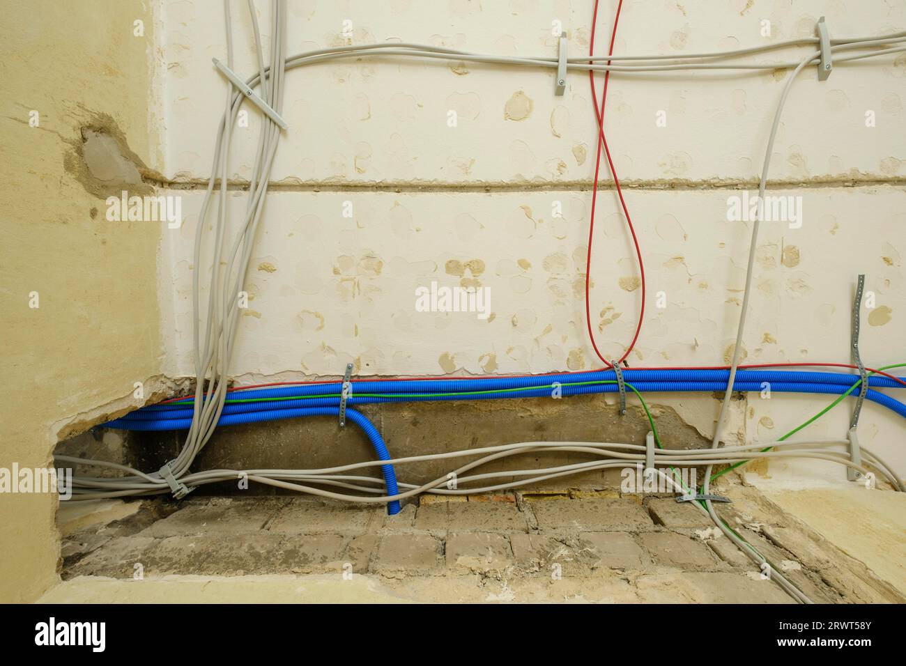 Power cables, empty conduits and network cables under the ceiling ...