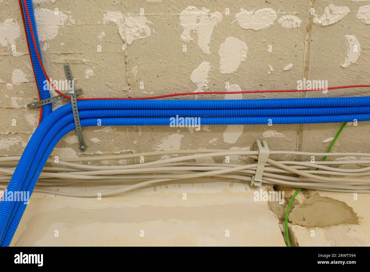 Electric cables and conduits under the ceiling, construction site ...