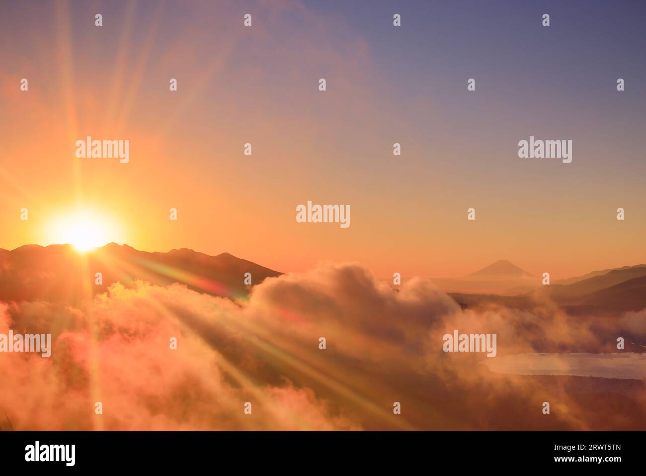 Mt. Fuji and the sea of clouds with the rising sun from the Yatsugatake ...
