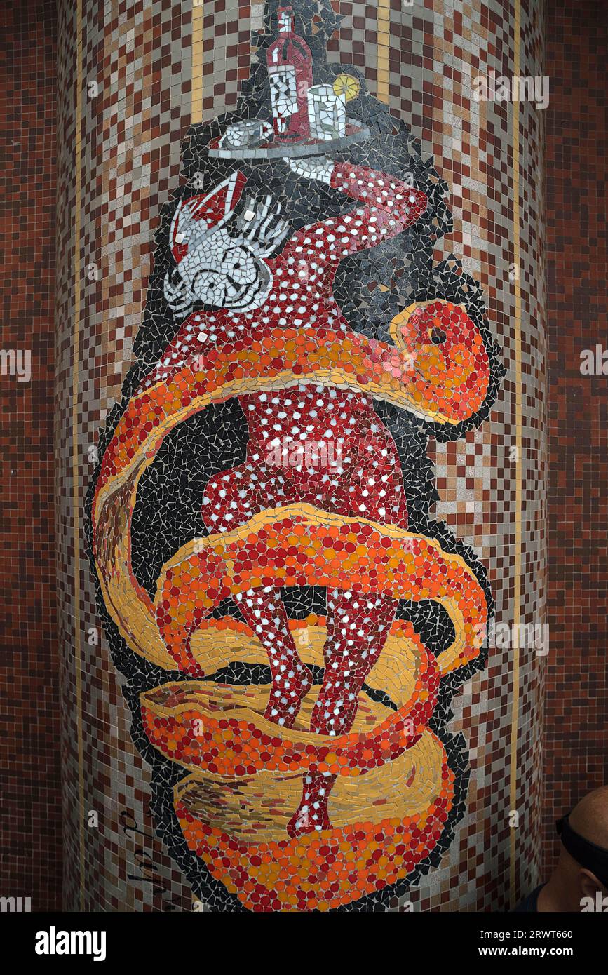 Mosaic motif of a waiter on a column in front of a bistro, Paris ...