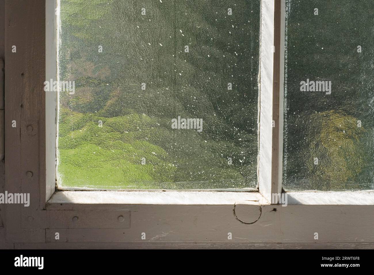 An old window frame with single glazing in ornamental glass Stock Photo ...