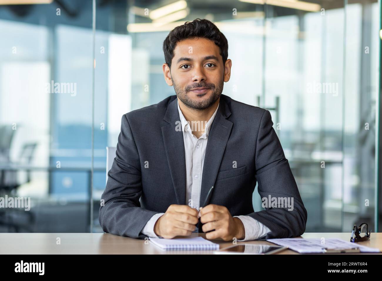 Portrait of a young investor banker at the workplace inside the bank ...