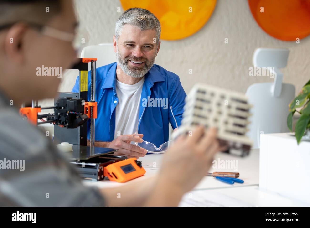 Architects making house model working with 3D printer, creating process ...