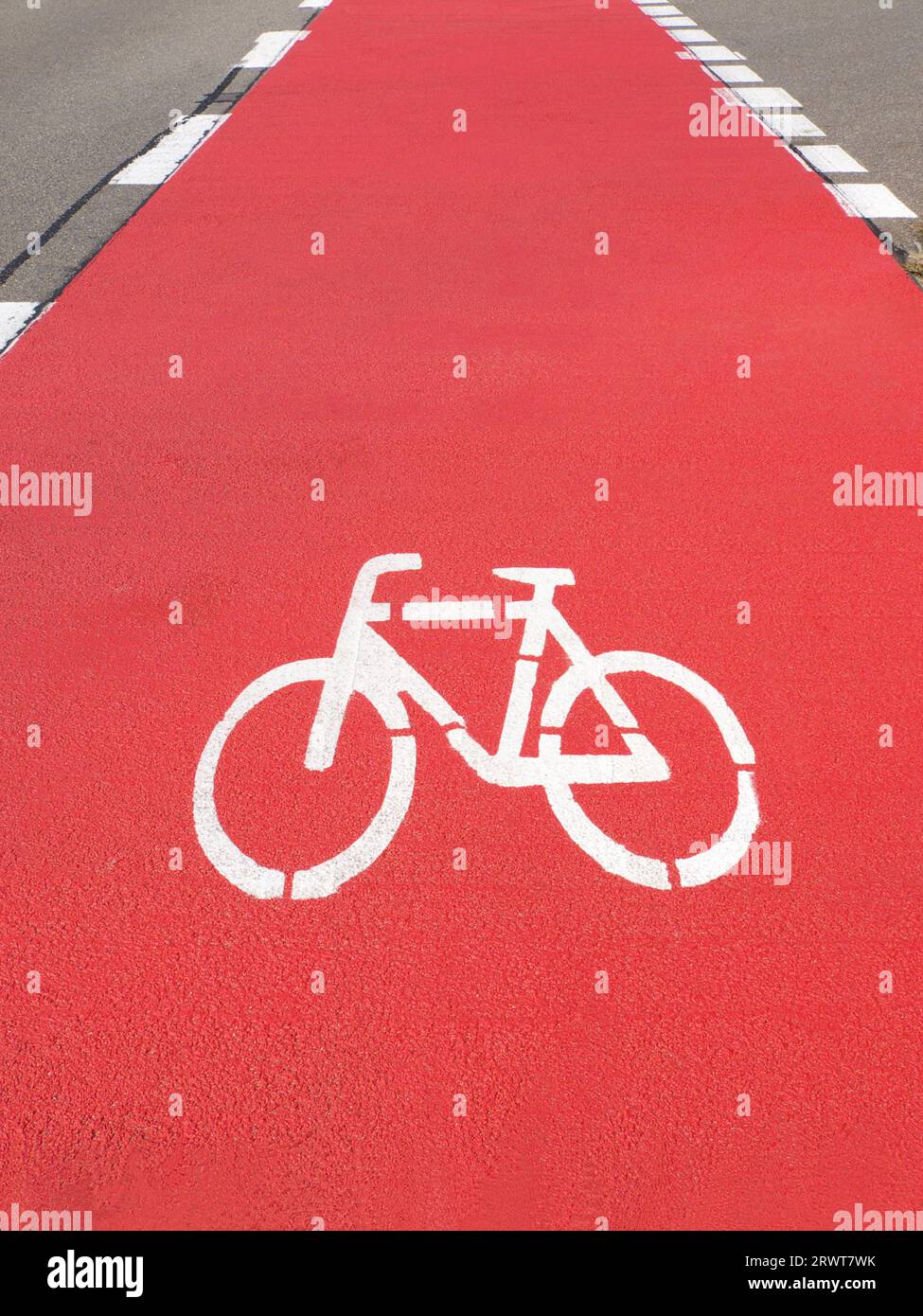 Red marked bicycle path with bicycle symbol Stock Photo - Alamy