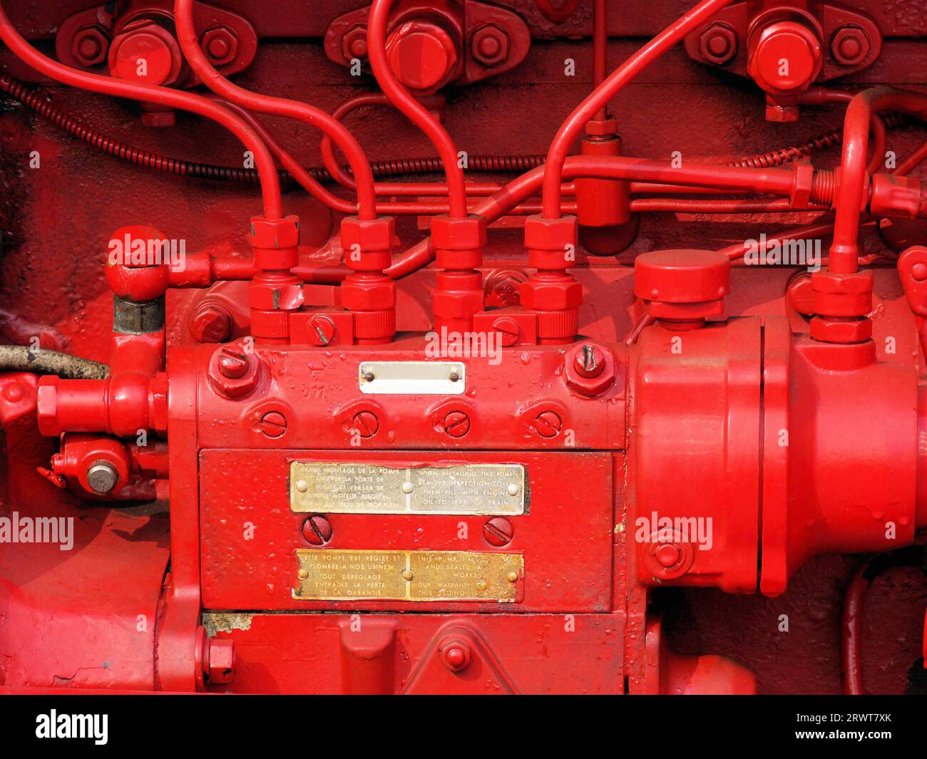 Red injection pump of a tractor, format-filling Stock Photo - Alamy