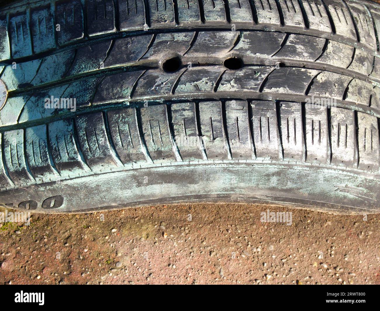 Old tyre covered with verdigris, buried in the earth Stock Photo - Alamy