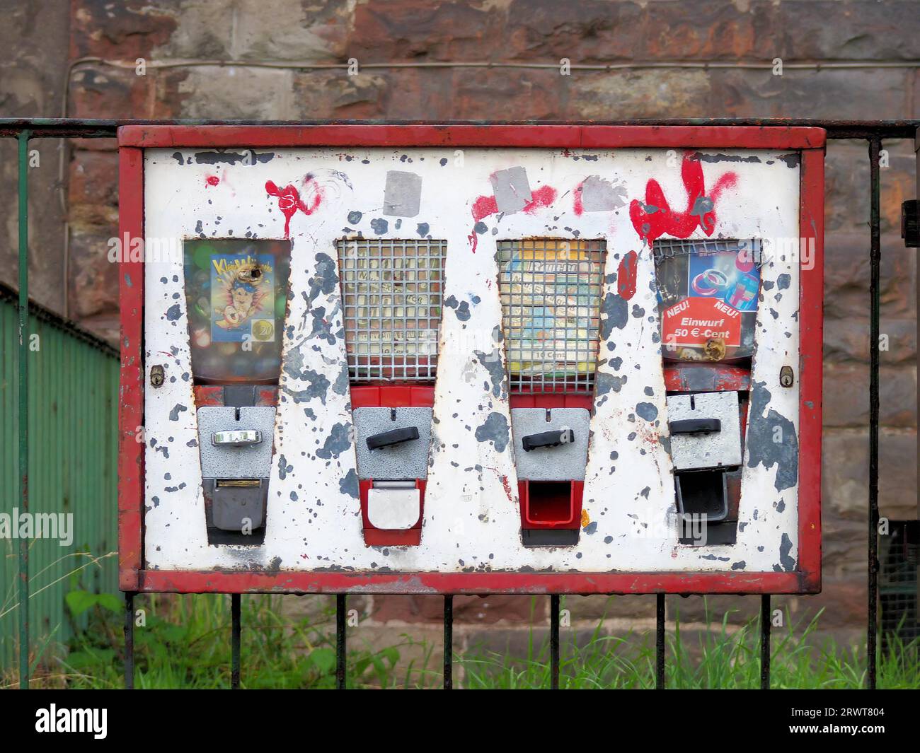 Four connected chewing gum vending machines, in the background house ...