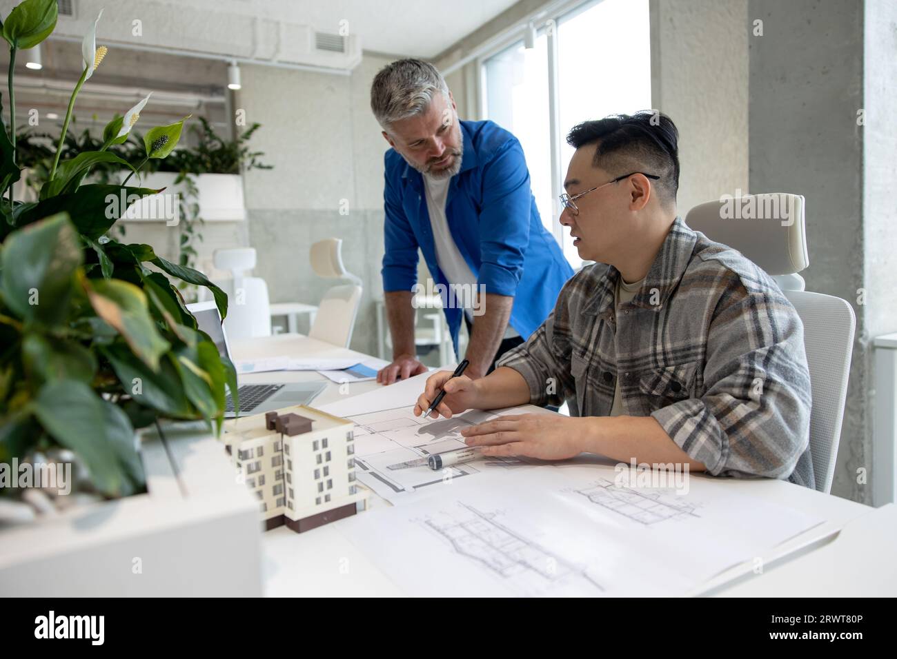 Men working with 3D printer and blueprint for designing mechanical ...