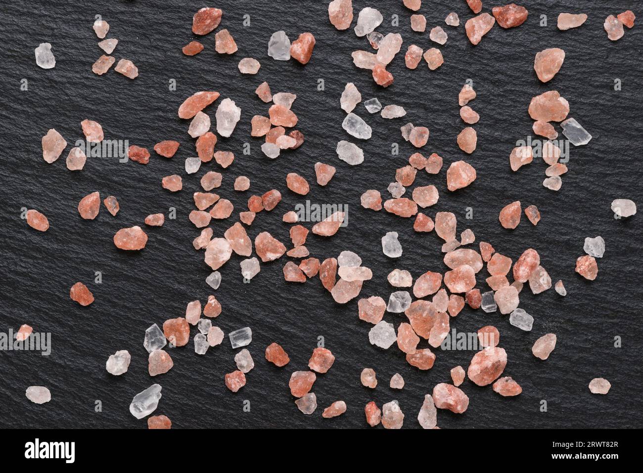 pink Himalayan salt used for spice and condiment in cooking on black ...