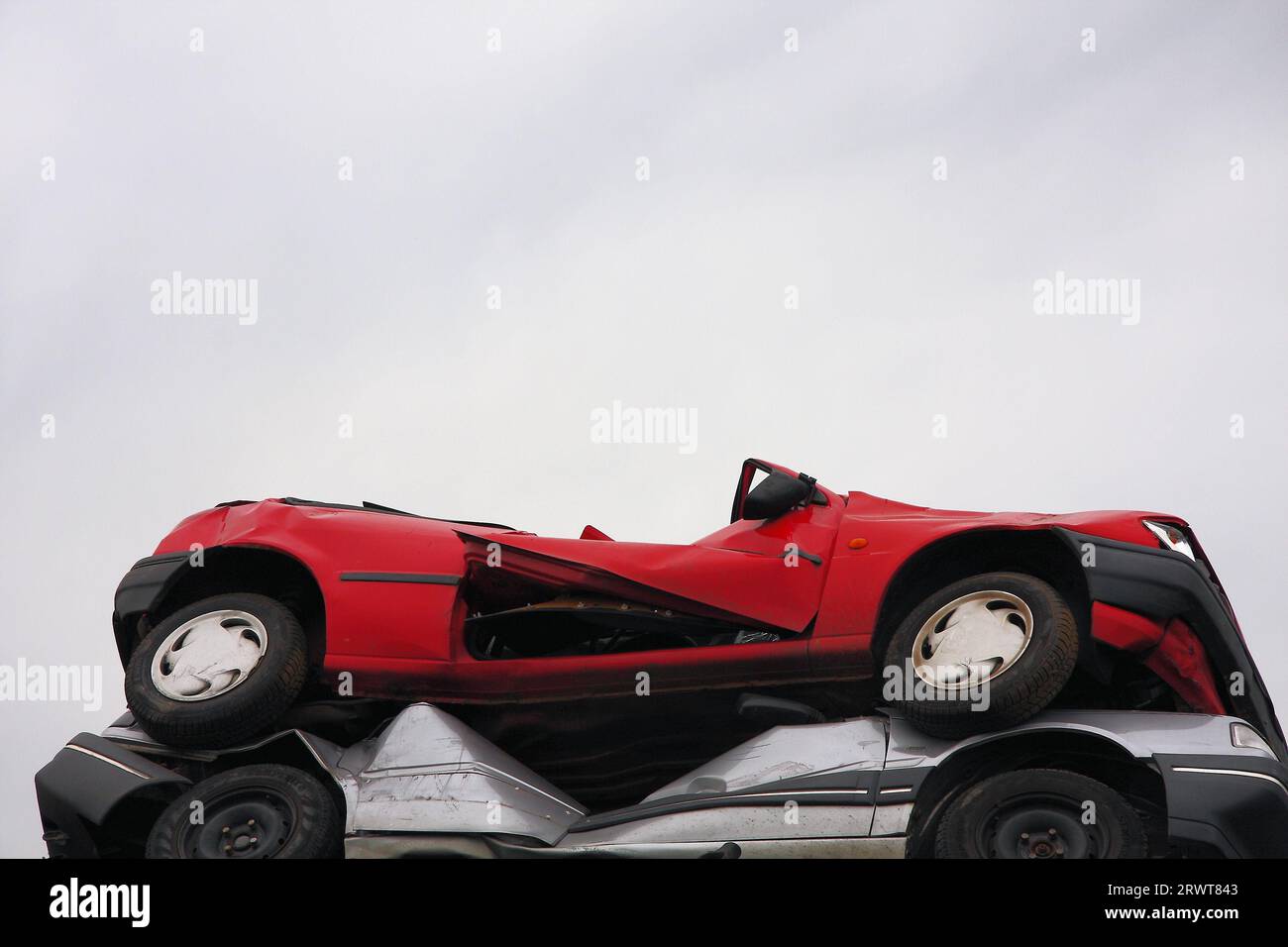 Two scrap cars, red and silver, cut-out Stock Photo - Alamy