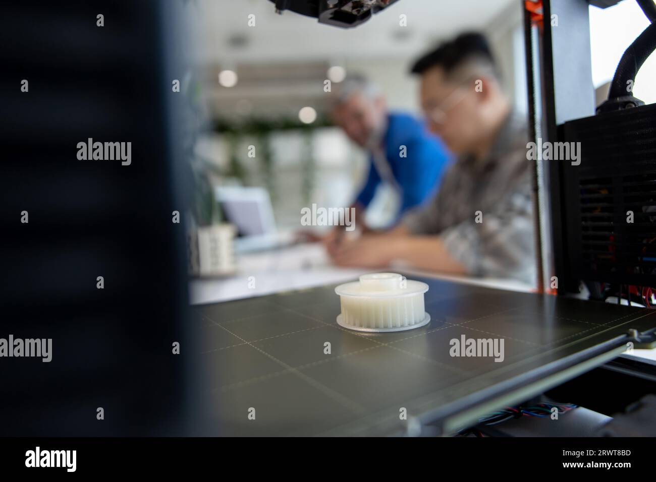 Two men architects using 3D printer in office and projecting house ...