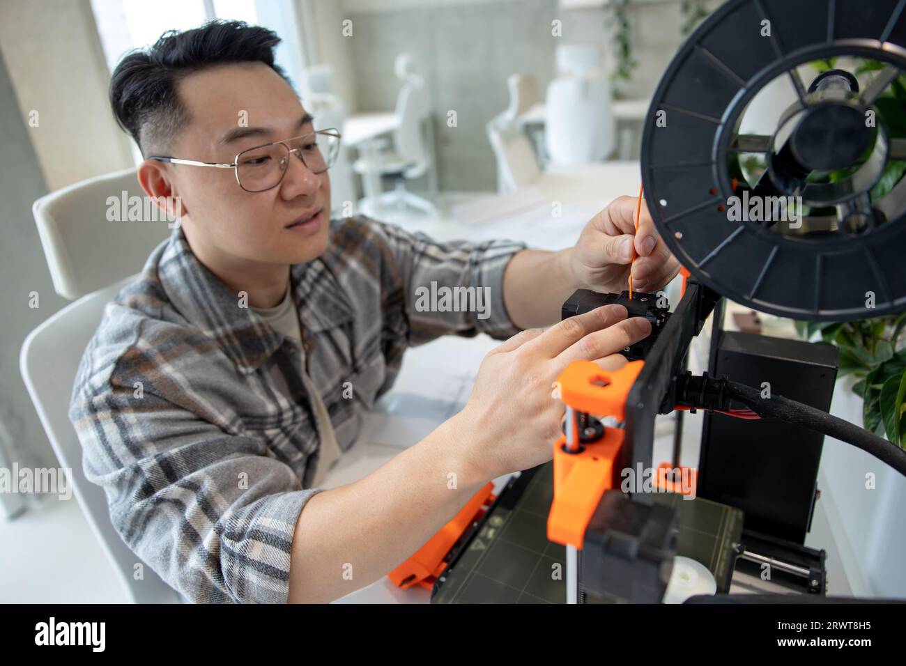 Engineering man designing mechanical parts using 3D printer in office Stock Photo - Alamy