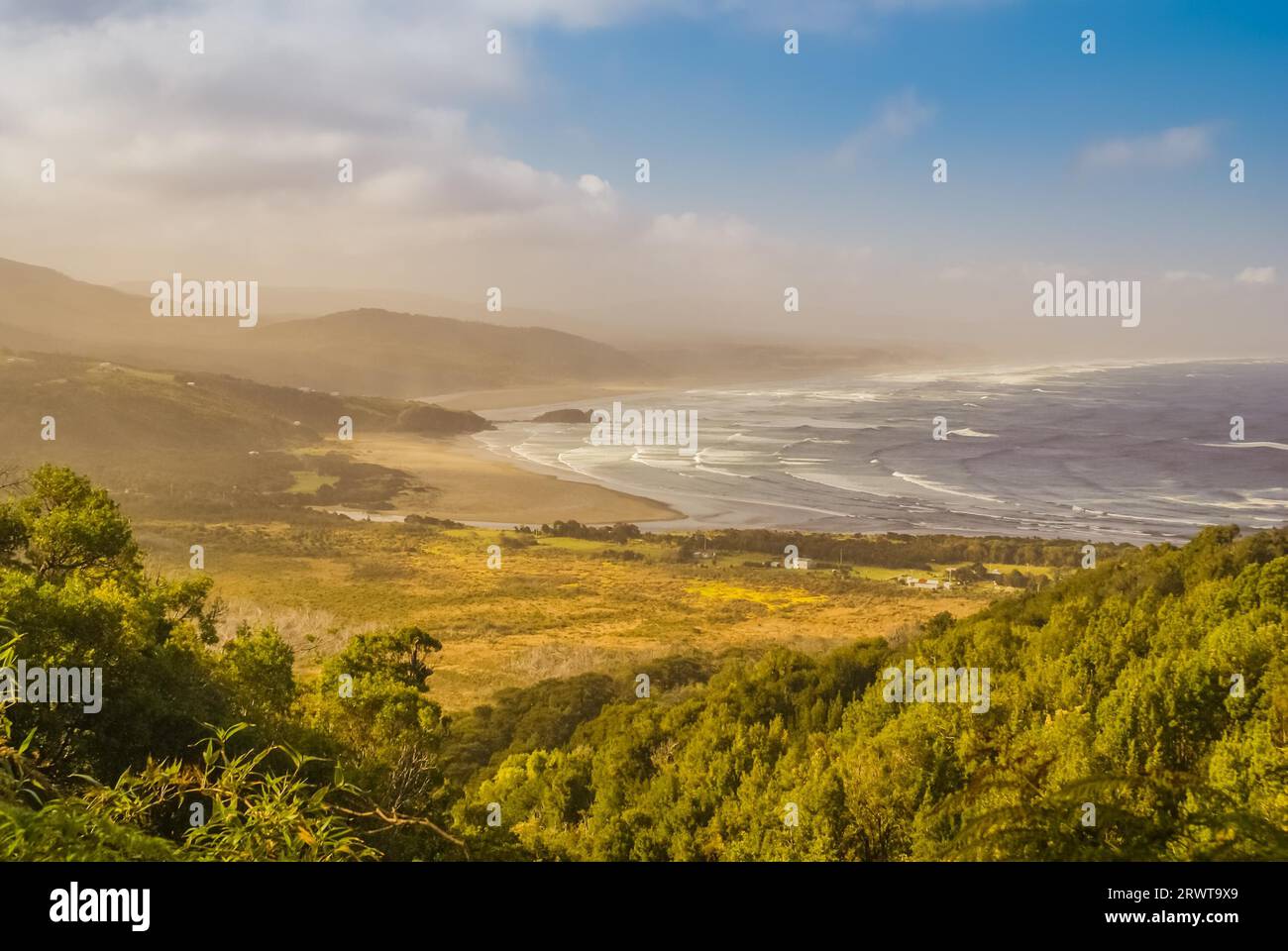 Countryside with sea and beach in distance in Parque Nacional Chiloe in ...