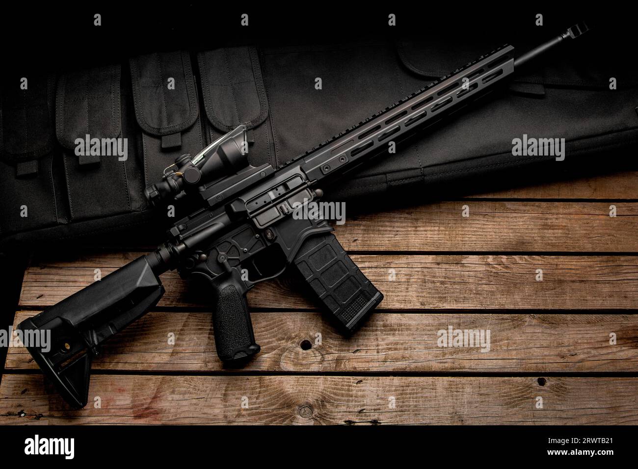 Modern automatic rifle on a wooden background. Weapons for police ...