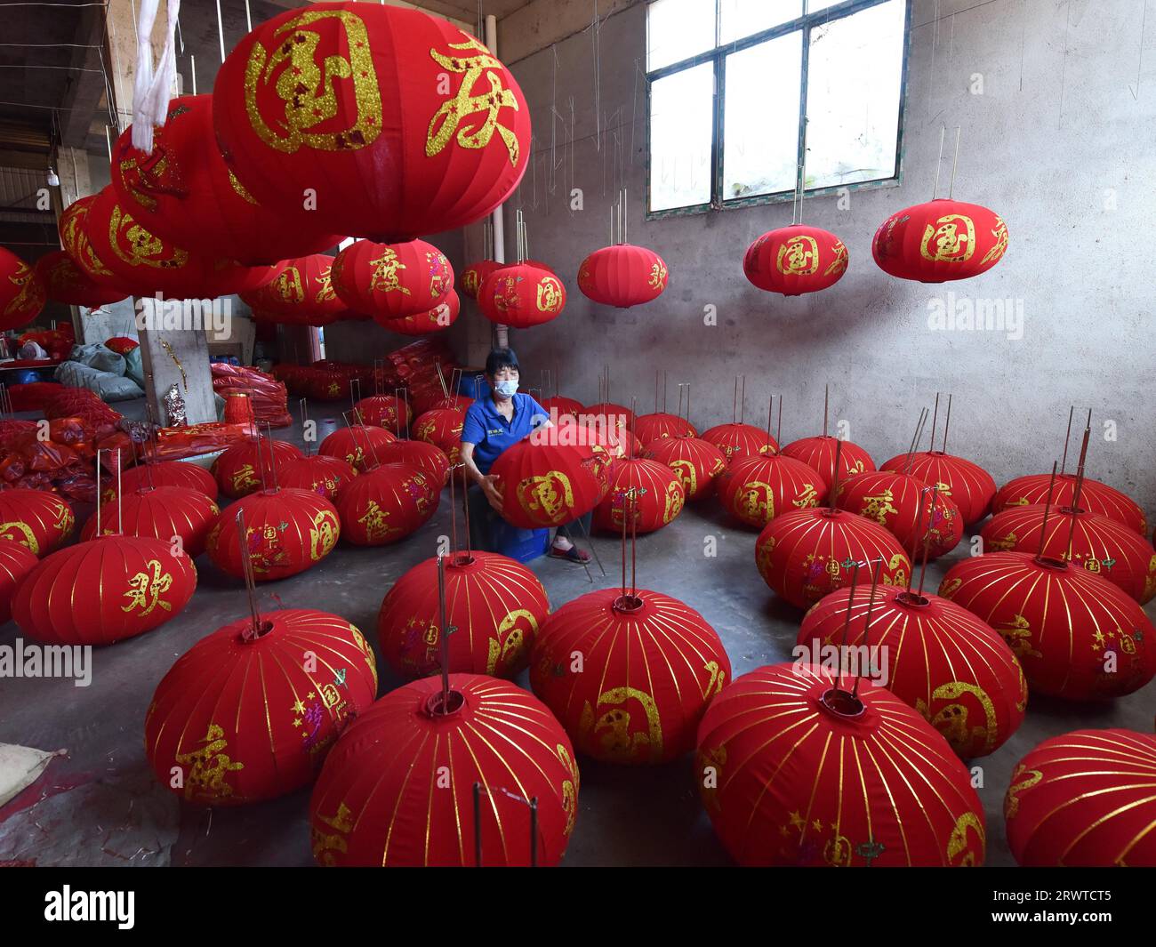 Workers make red lanterns for the upcoming Mid-Autumn Festival and ...