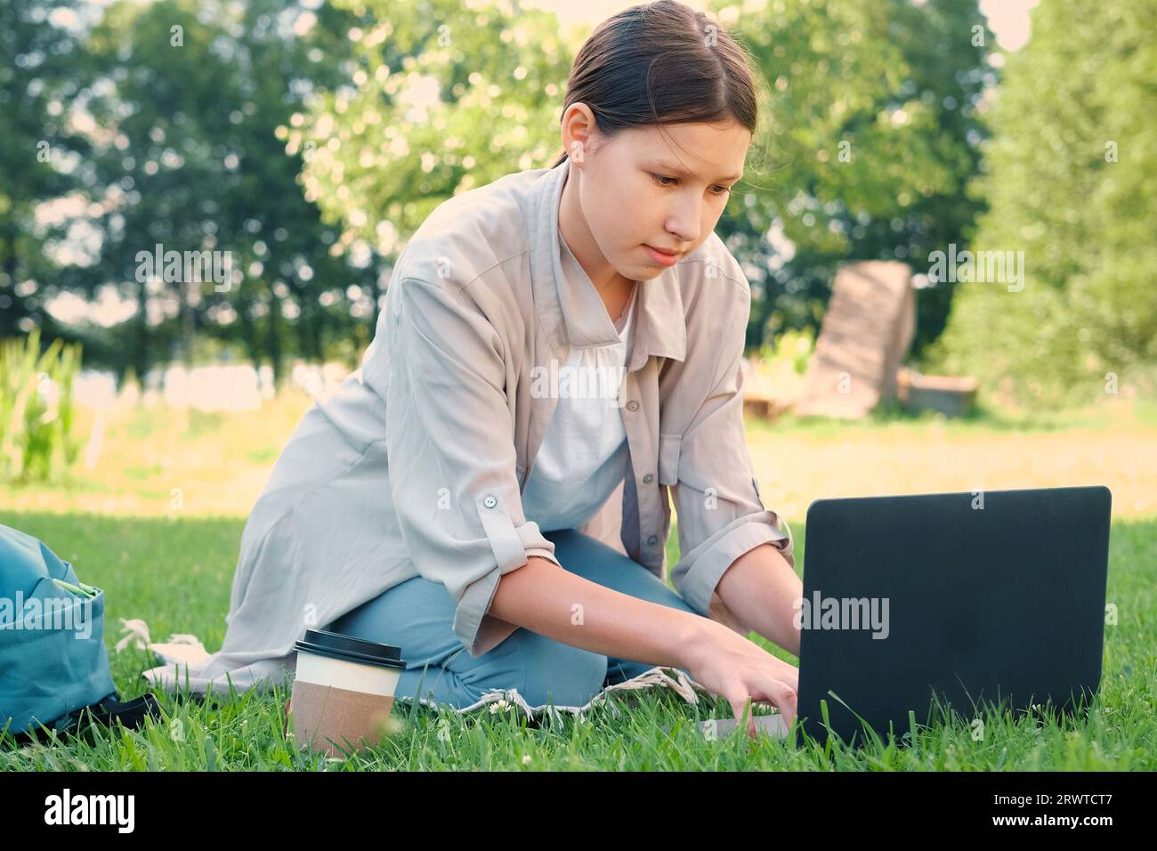 Teenage schoolgirl studying reading her books, tablet and notebook ...