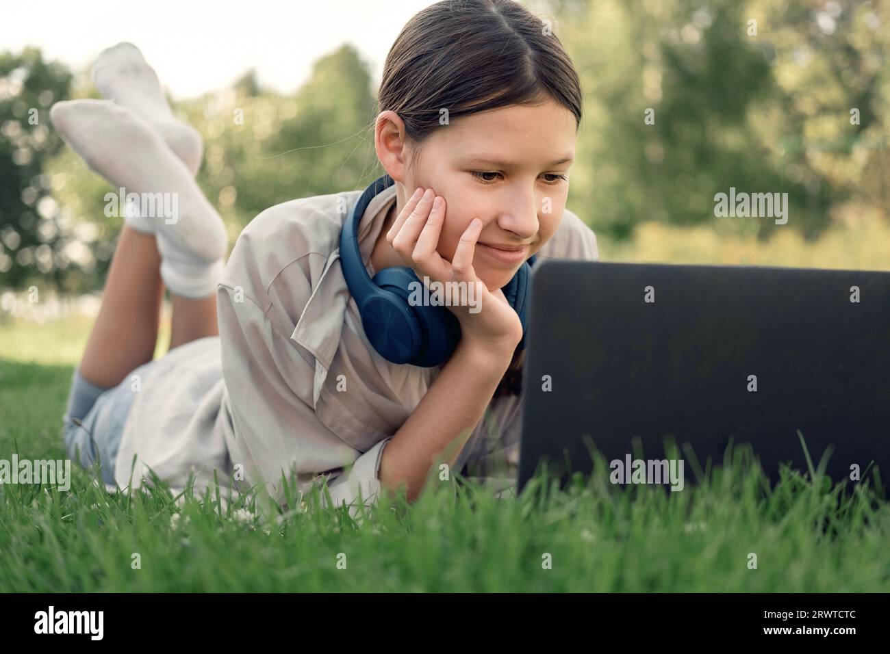 Teenage schoolgirl studying reading her books, tablet and notebook ...