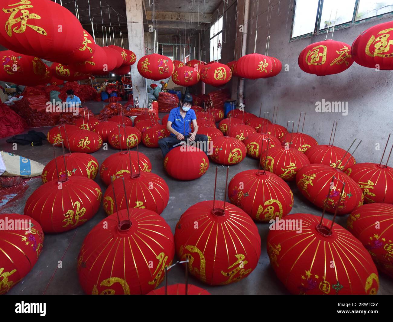 Workers make red lanterns for the upcoming Mid-Autumn Festival and ...