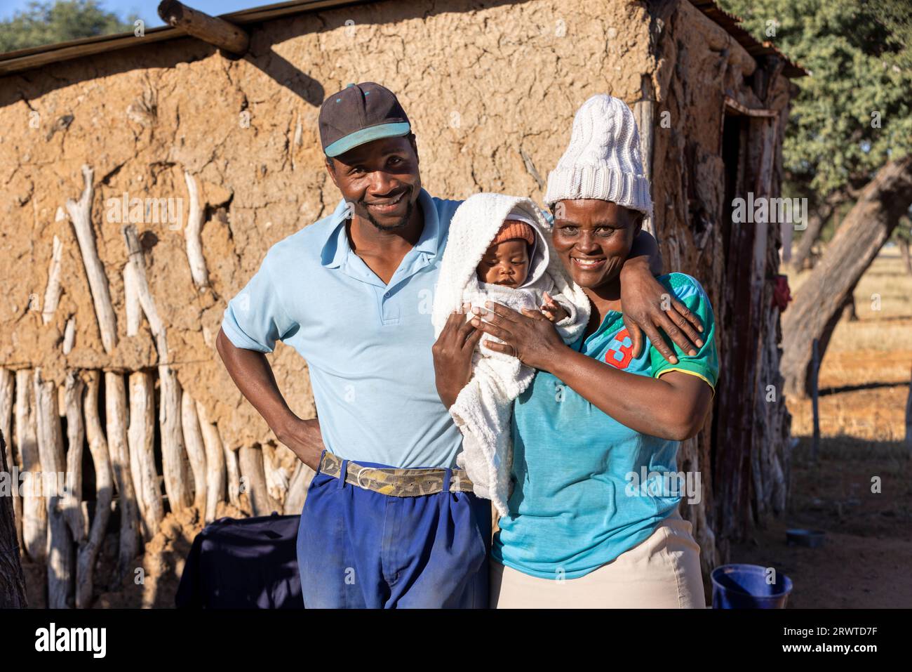 happy african family, smiling parents hugging and holding the baby in ...