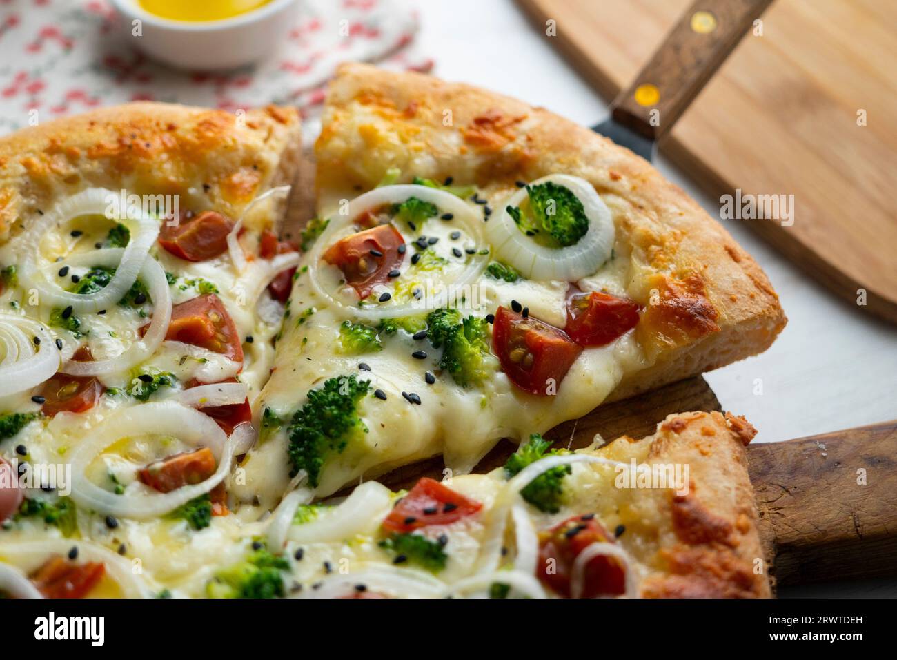 Neapolitan pizza with cheese, onion, broccoli and cherry tomatoes Stock ...