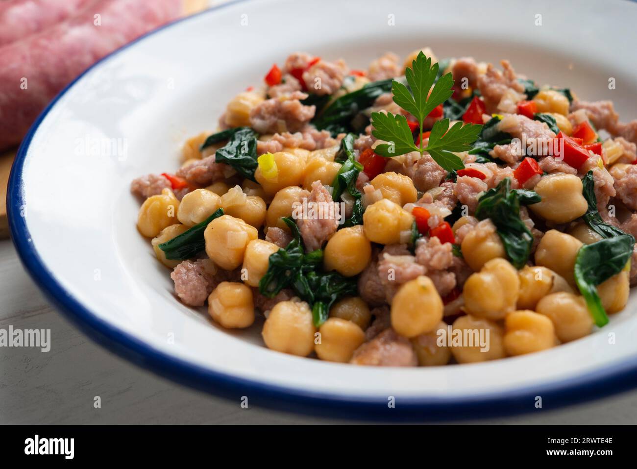 Chickpea salad with spinach, minced pork and red pepper Stock Photo - Alamy