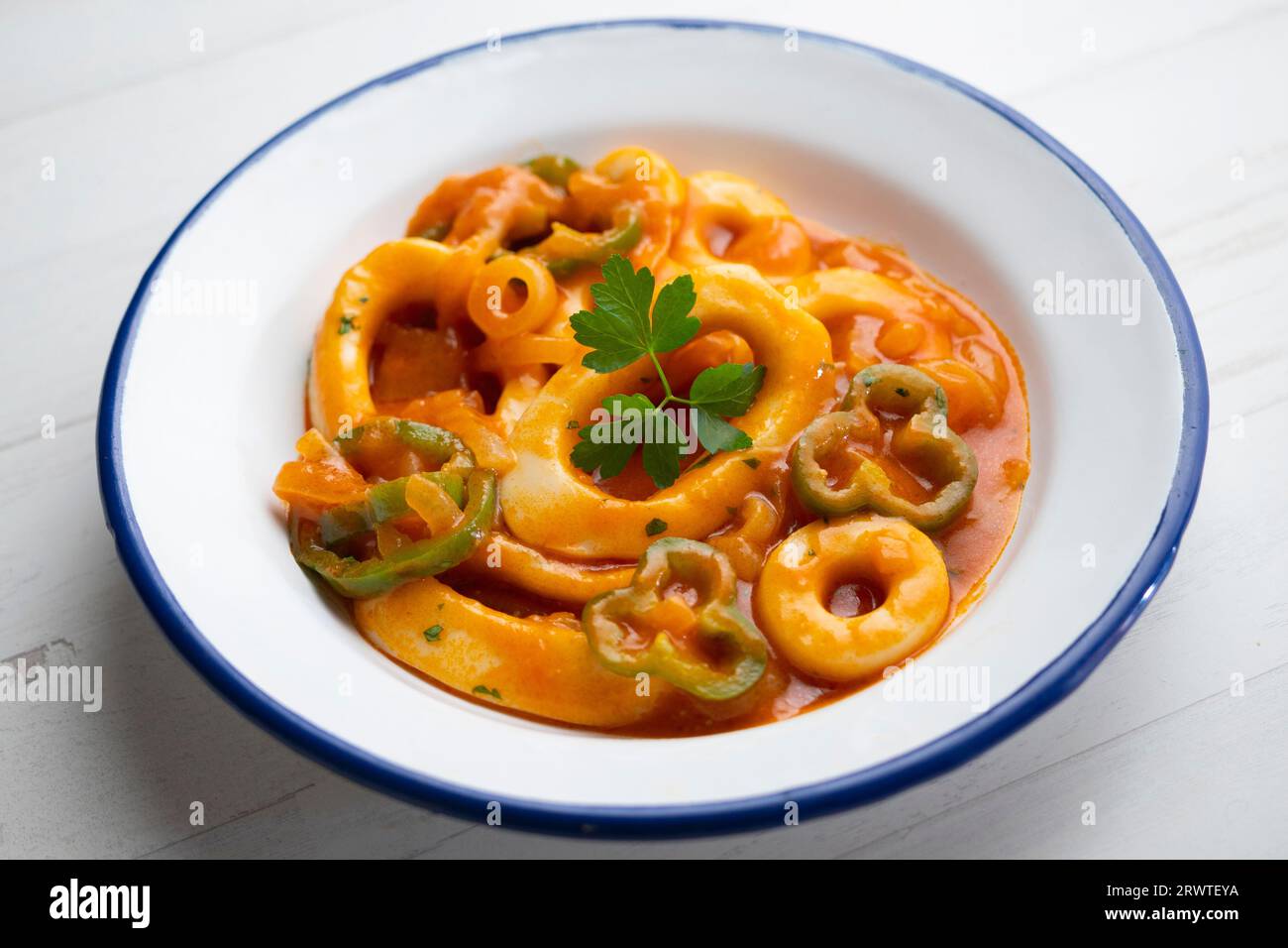 Stewed squid rings cooked with potatoes and vegetables Stock Photo - Alamy