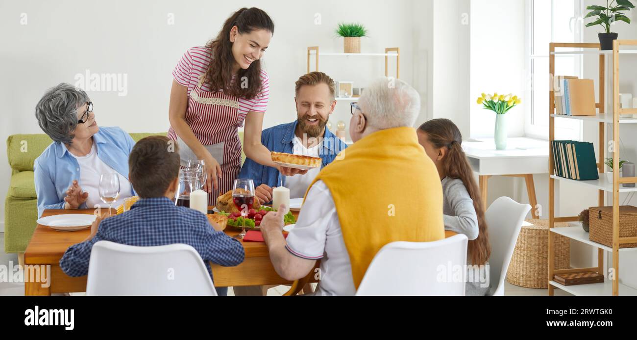 Family of three generations sitting at dinner table Stock Photo - Alamy