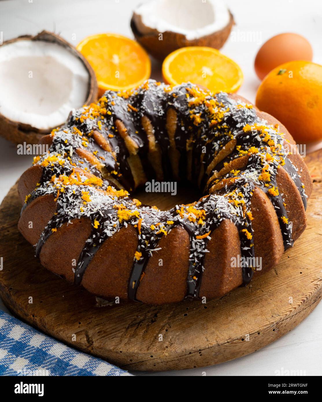 Orange and coconut cake made with a round mold and covered in dark ...