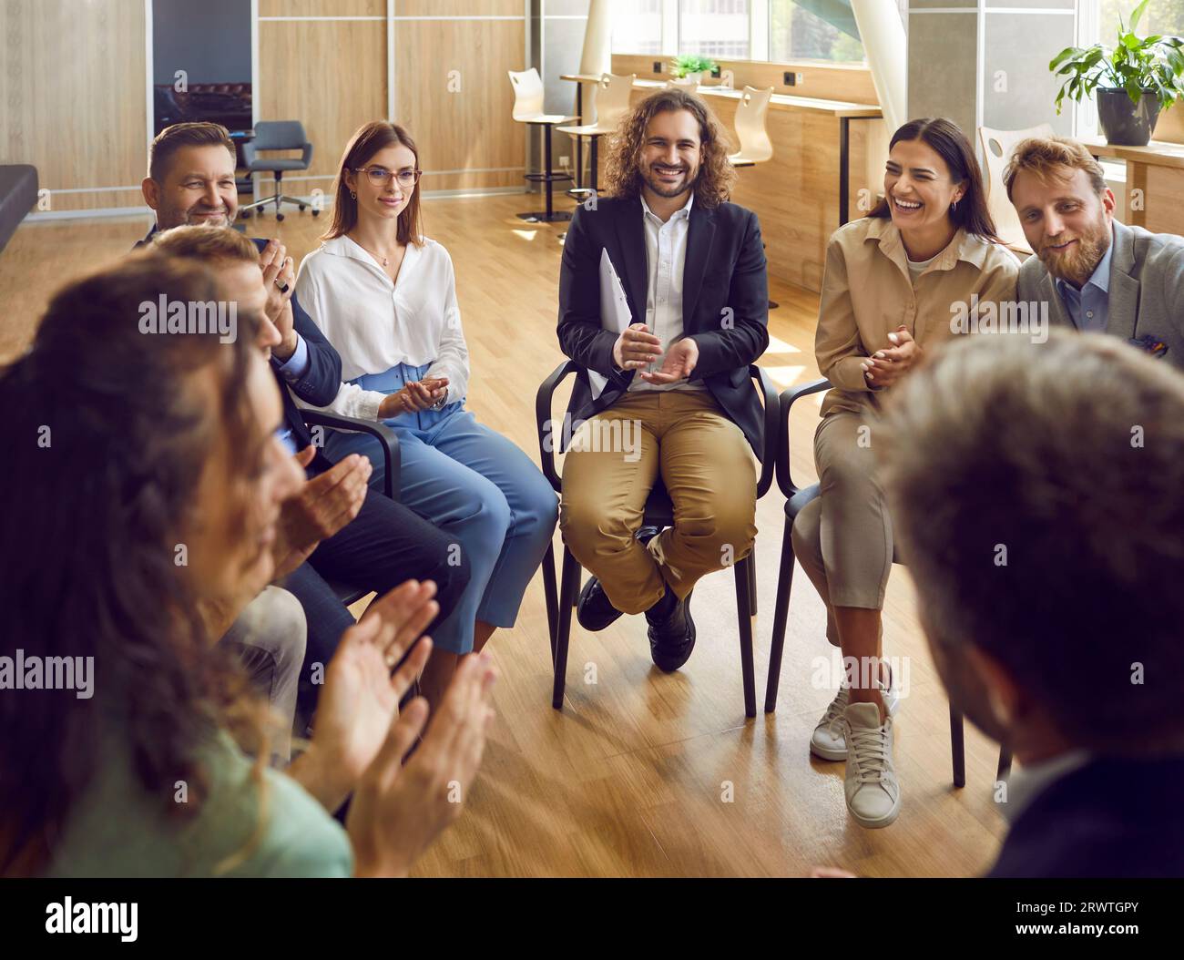Group of staff and company employees talking in a meeting room sitting ...