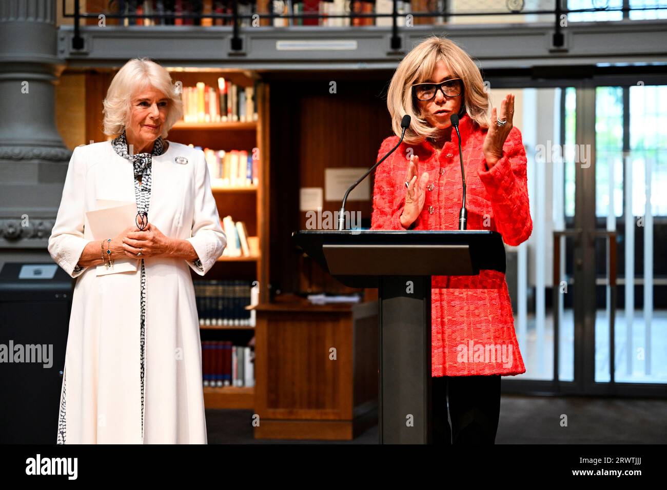 French President's wife Brigitte Macron, right, delivers a speech as ...