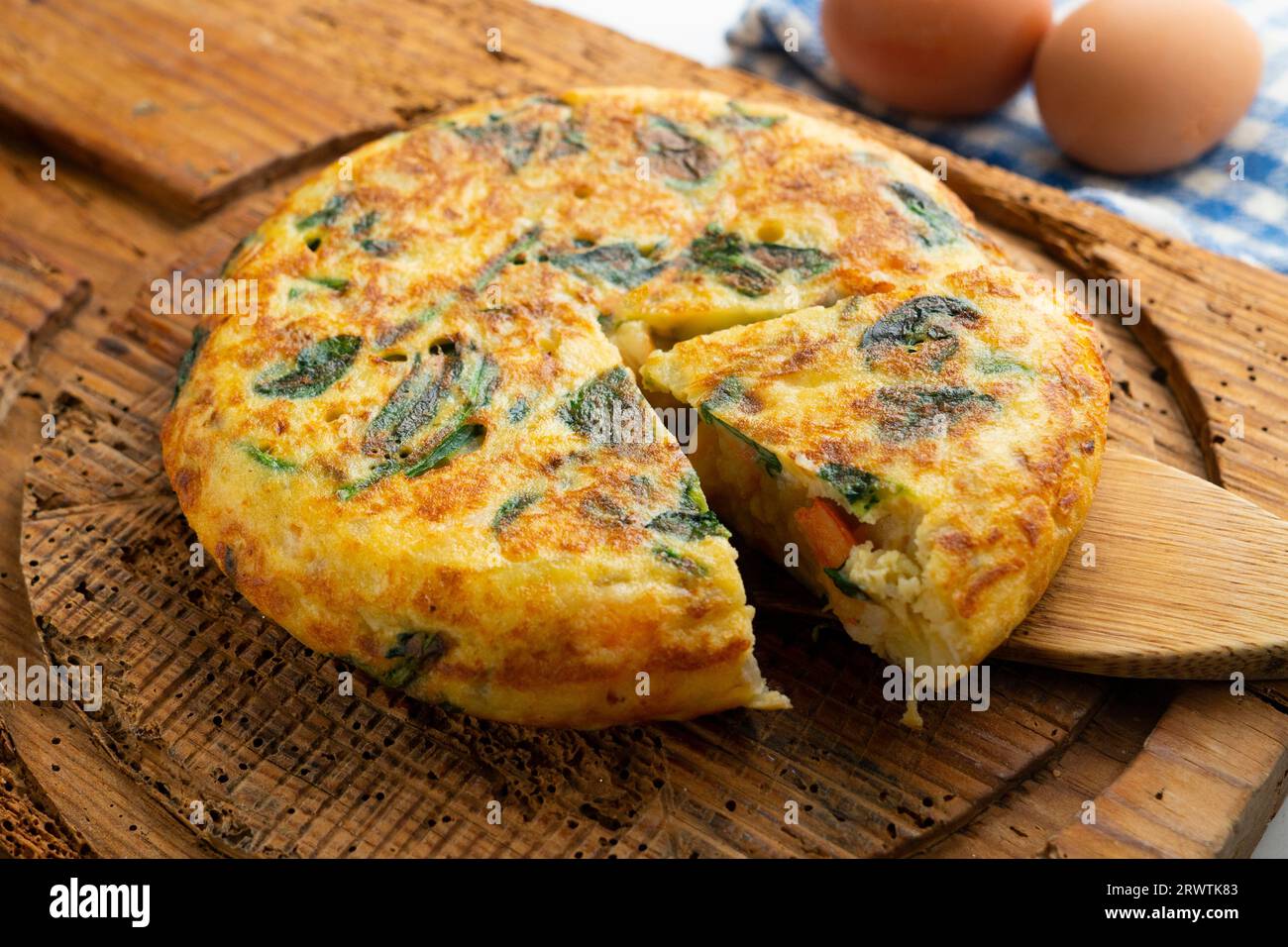 Spanish potato omelet with shrimp and spinach. Traditional Spanish tapa ...
