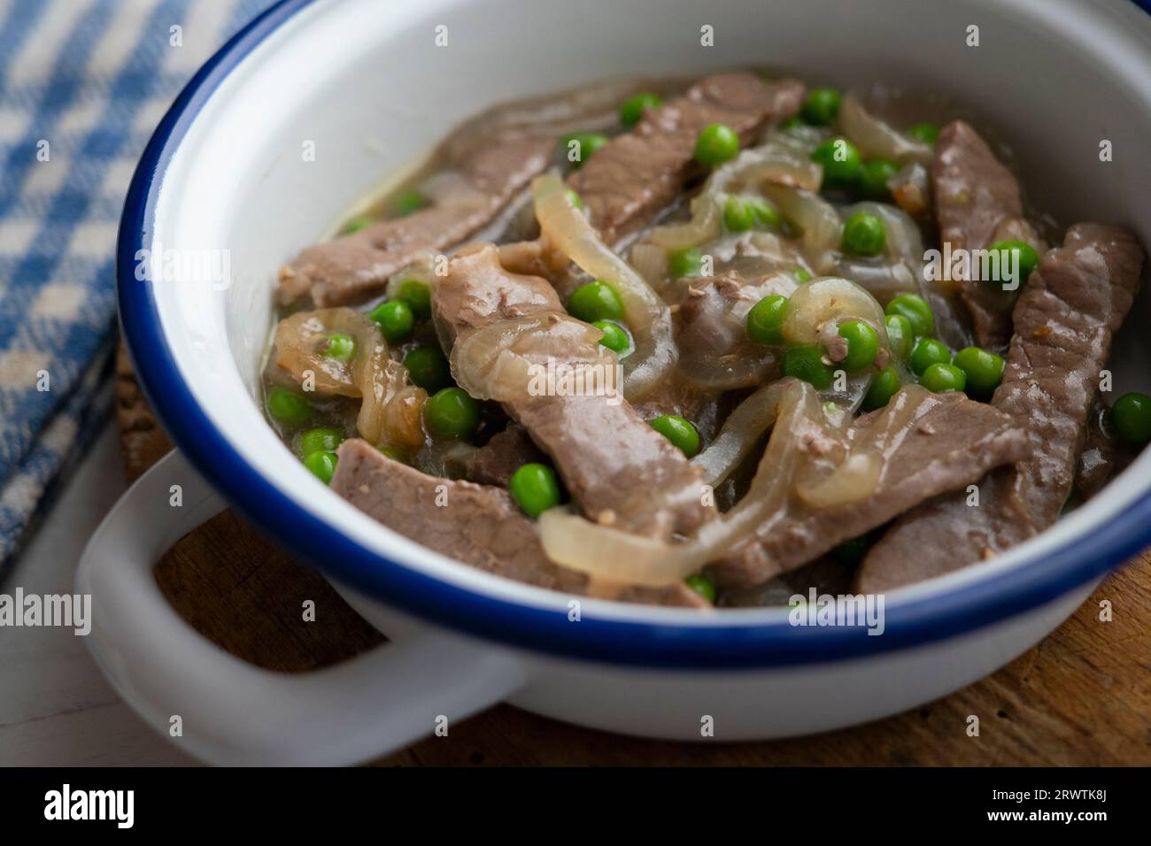 Beef strips cooked with onion and peas Stock Photo - Alamy