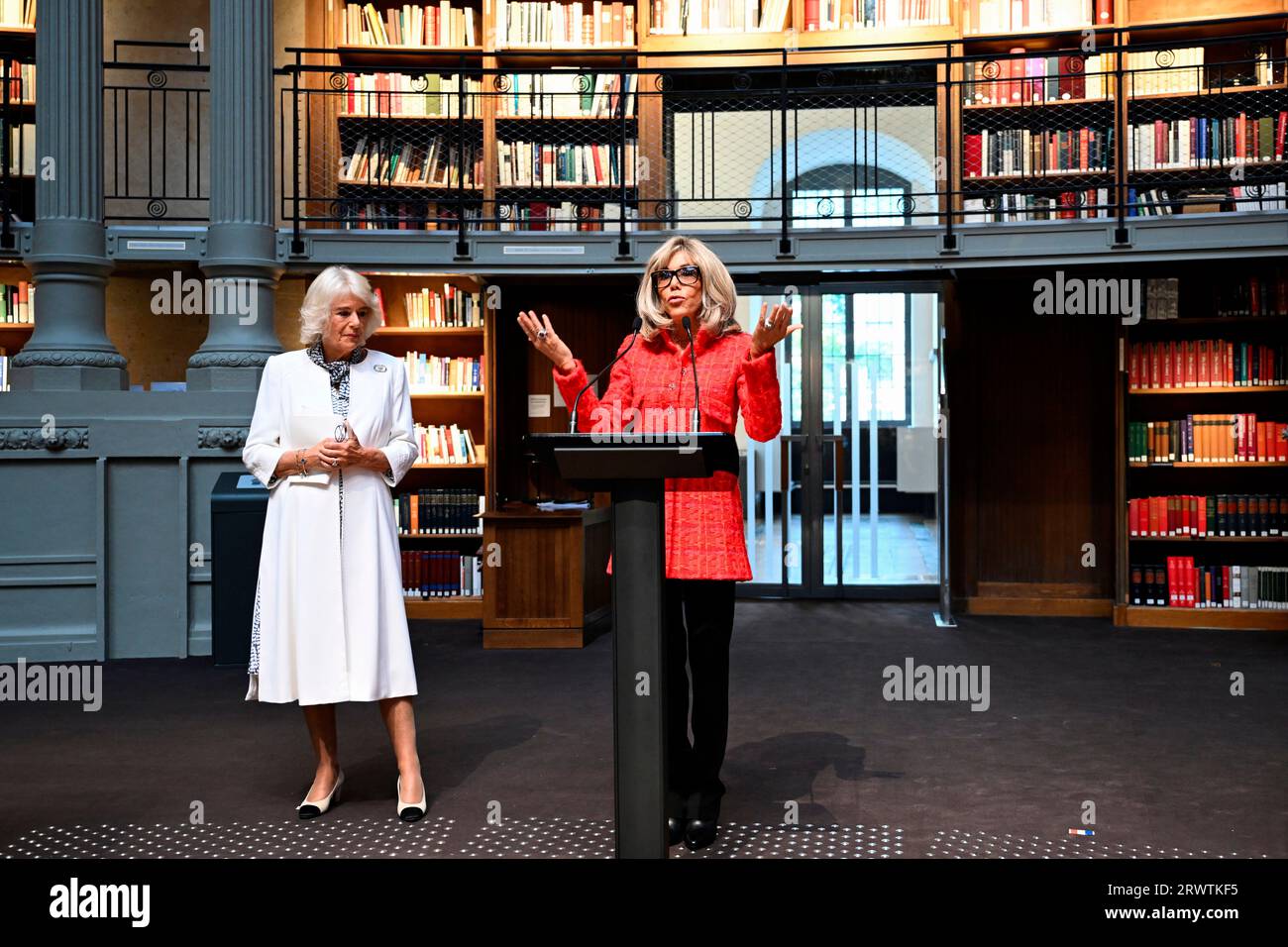 French President's wife Brigitte Macron, right, delivers a speech as ...
