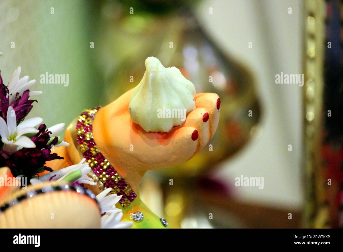 modak, prashadam of Lord Ganesha. Ganpati bappa is holding his favorite ...