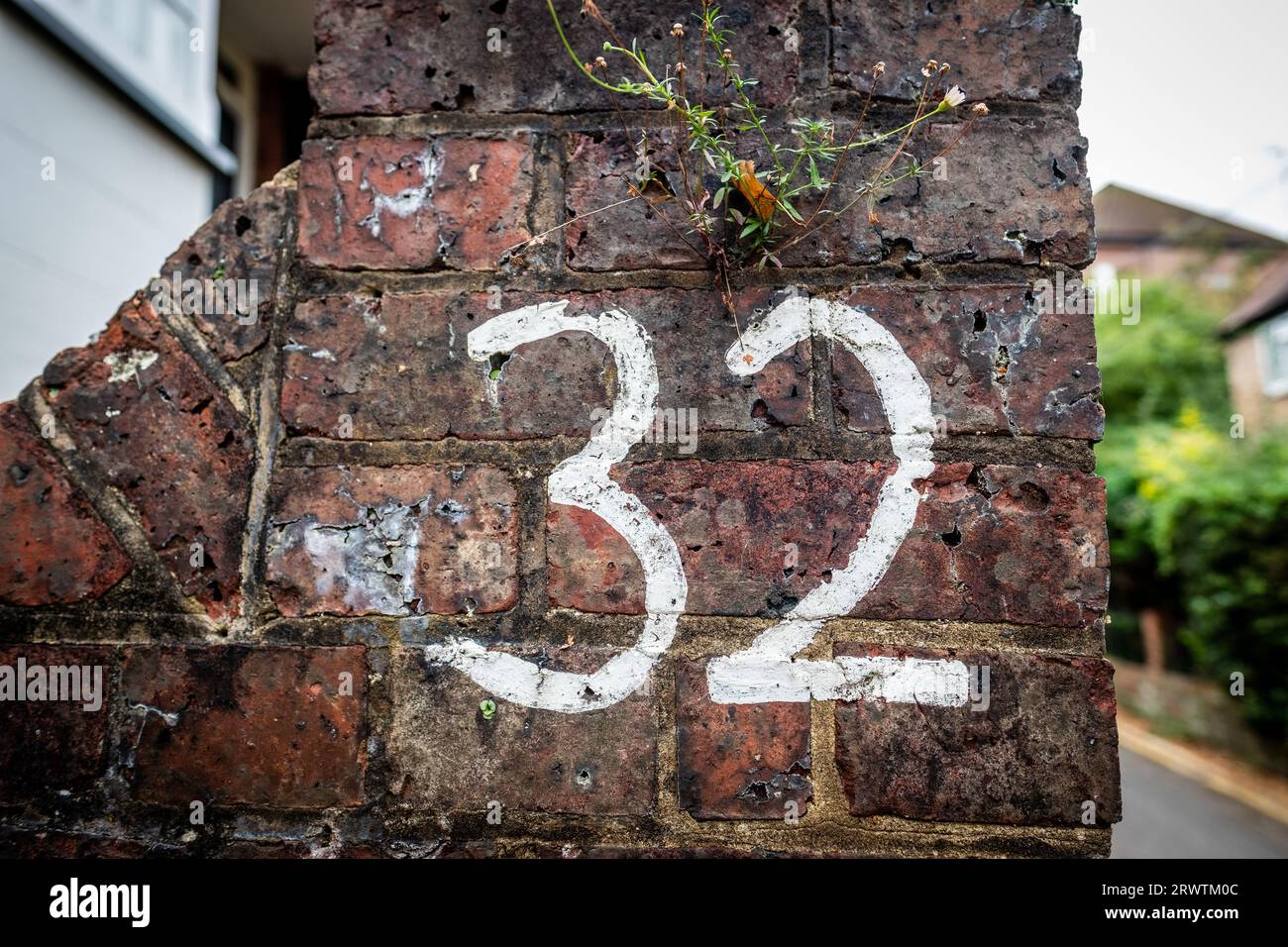 The Number 32 written on a old brick wall Stock Photo - Alamy