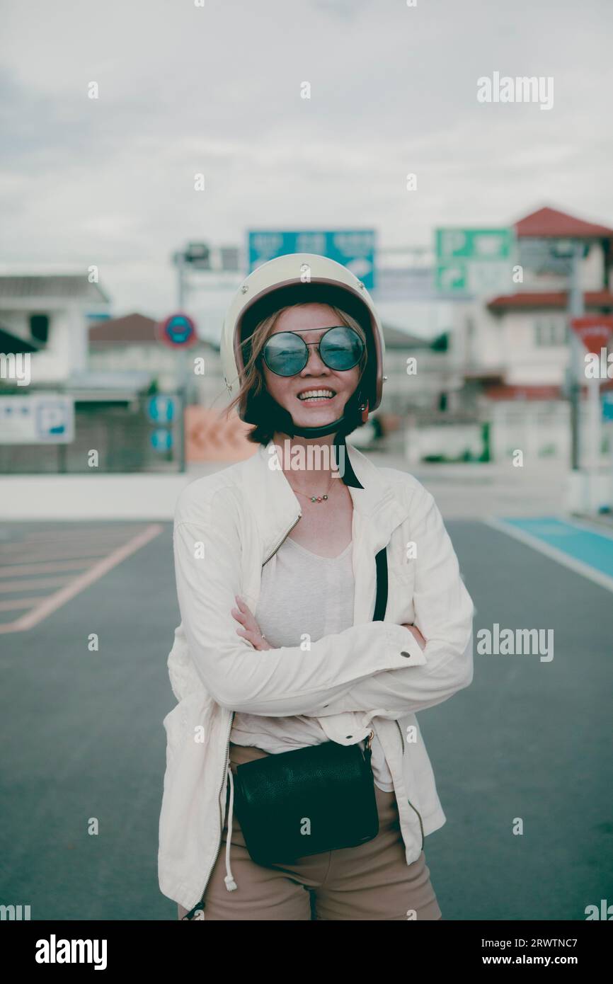 woman wearing safety helmet standing on city road toothy smile with ...