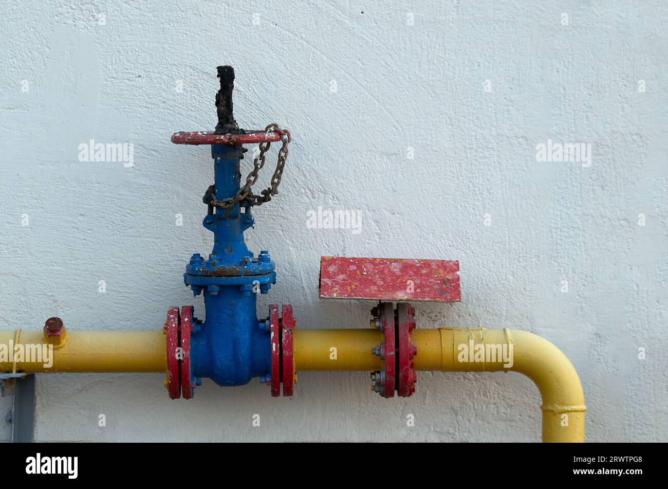 Gas pipe with valve on the background of a white wall Stock Photo - Alamy